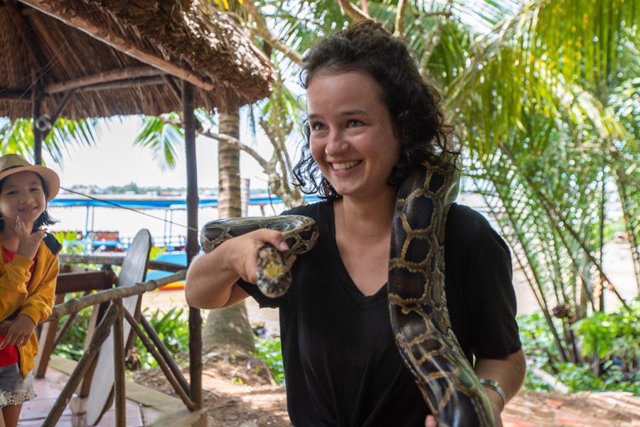 Tourist holding the pyton - Volunteer Overseas with IVI